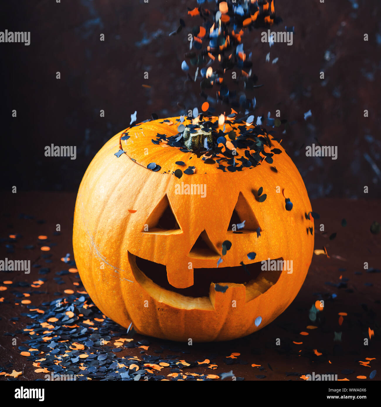 Halloween carved squash and confetti. Dark Holiday spooky background ...