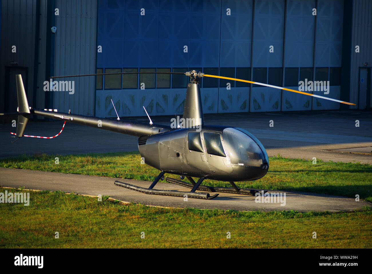 grey helicopter landed not in use Stock Photo - Alamy