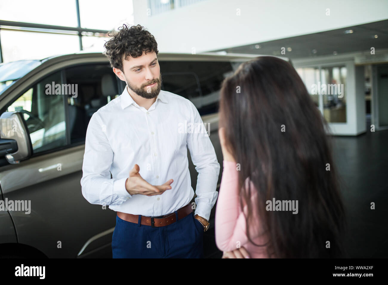 Professional salesperson selling cars at dealership to buyer Stock ...