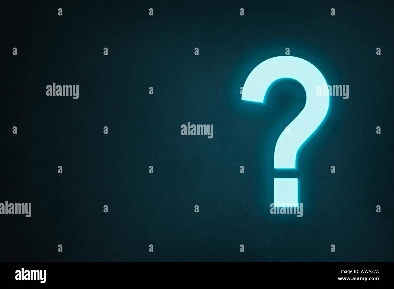 Neon question mark glows on a dark background, the concept of finding ...