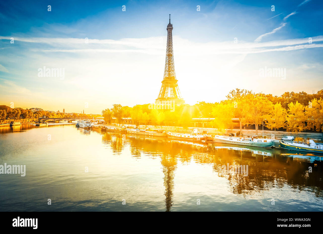 Paris Eiffel Tower reflecting in river Seine at sunrise in Paris ...