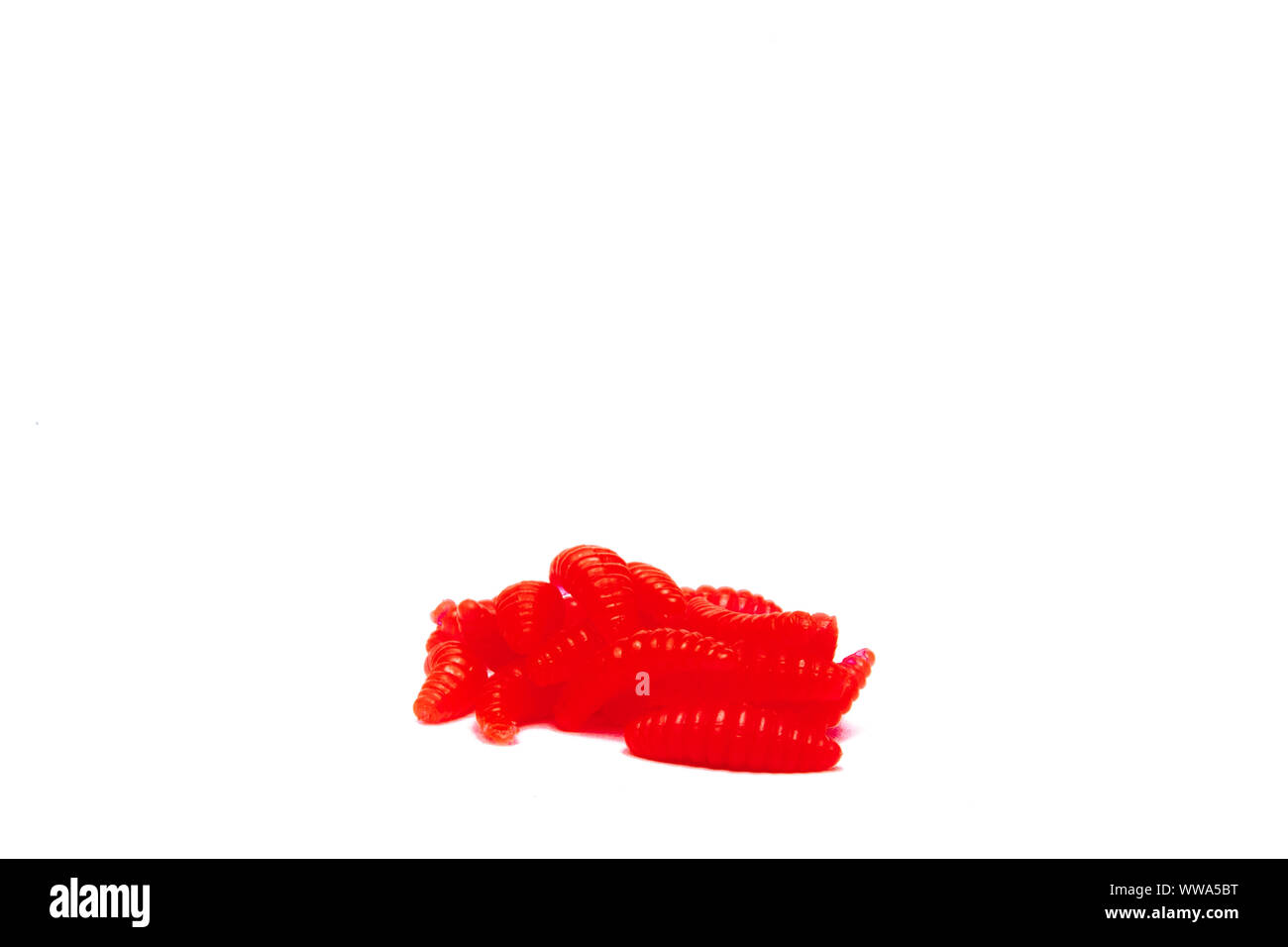 Red Artificial fishing larvae of insects on white background with soft ...