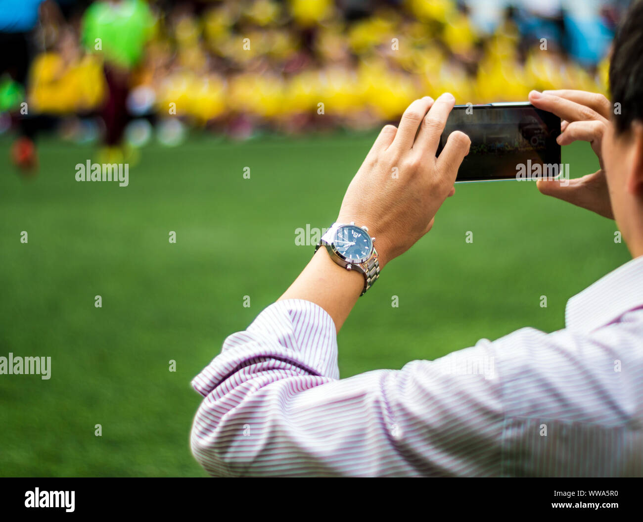 Man in work uniform, Watch and recording the football competitions ...