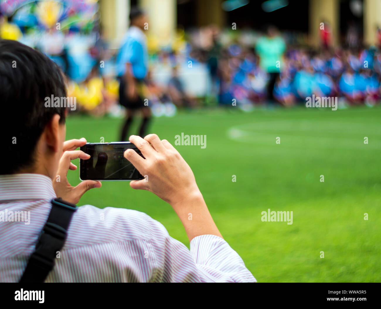 Man in work uniform, Watch and recording the football competitions ...