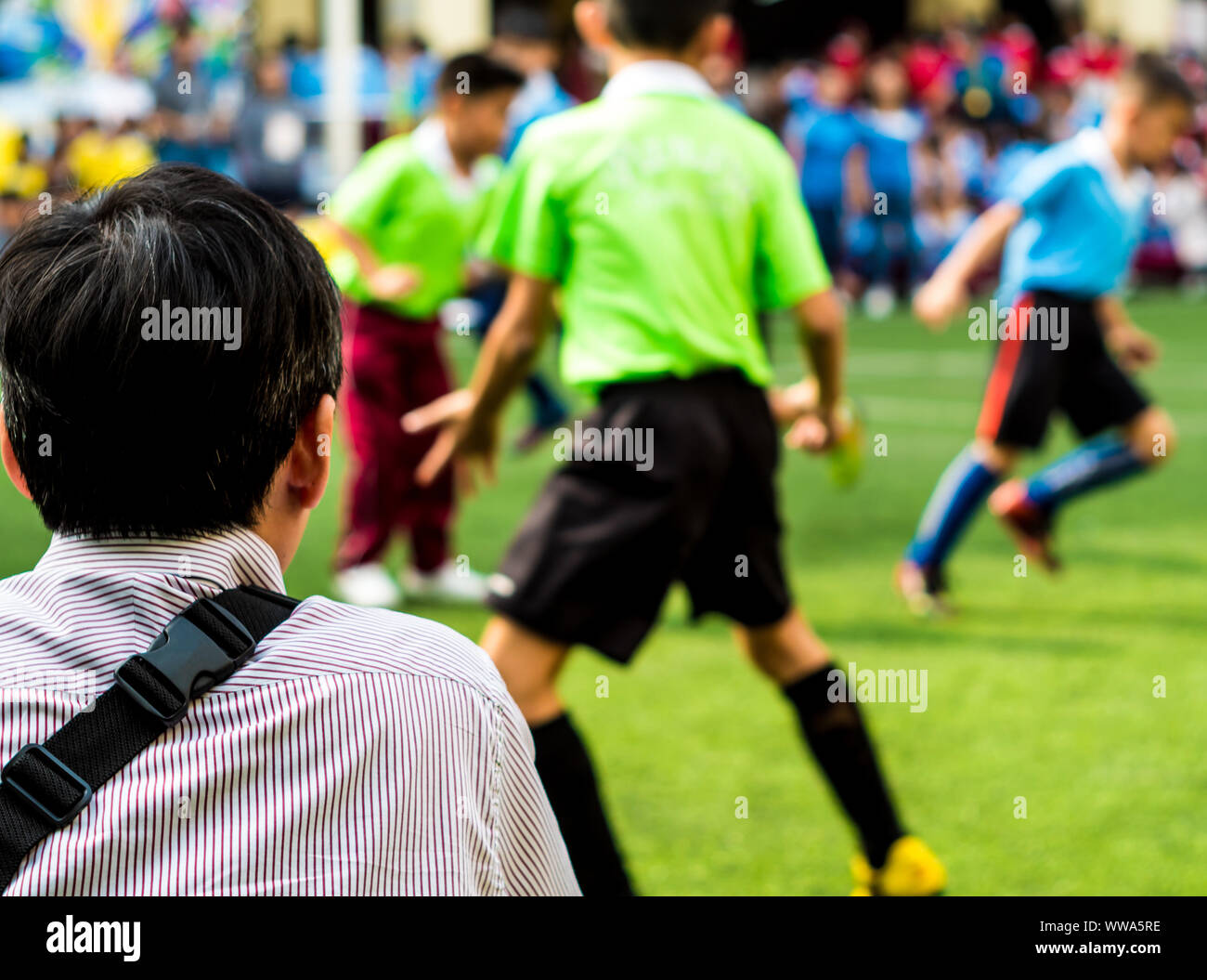 Man in work uniform, Watching the football competitions beside football ...
