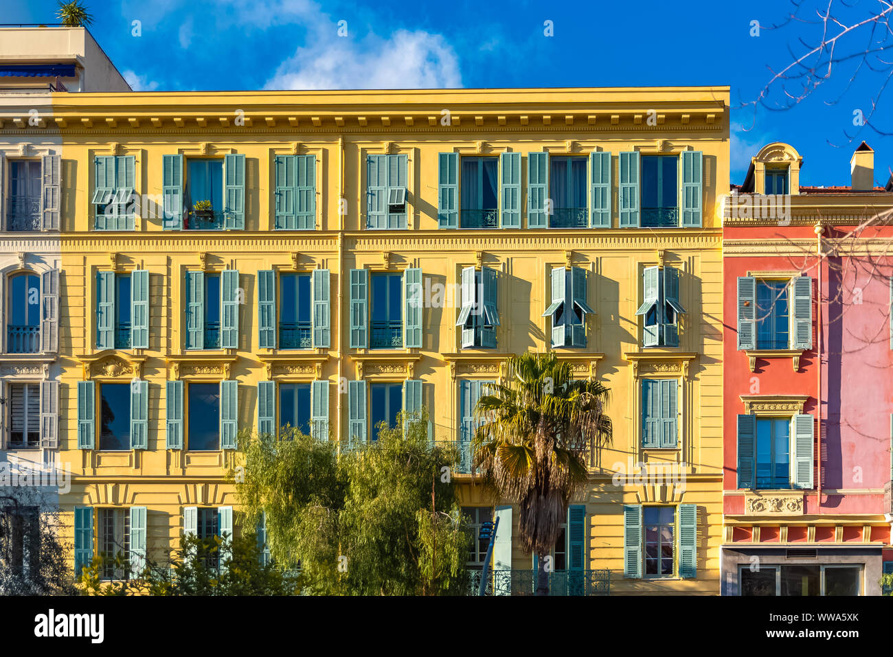 Nice, France, colorful facade, with typical windows and shutters, in a ...