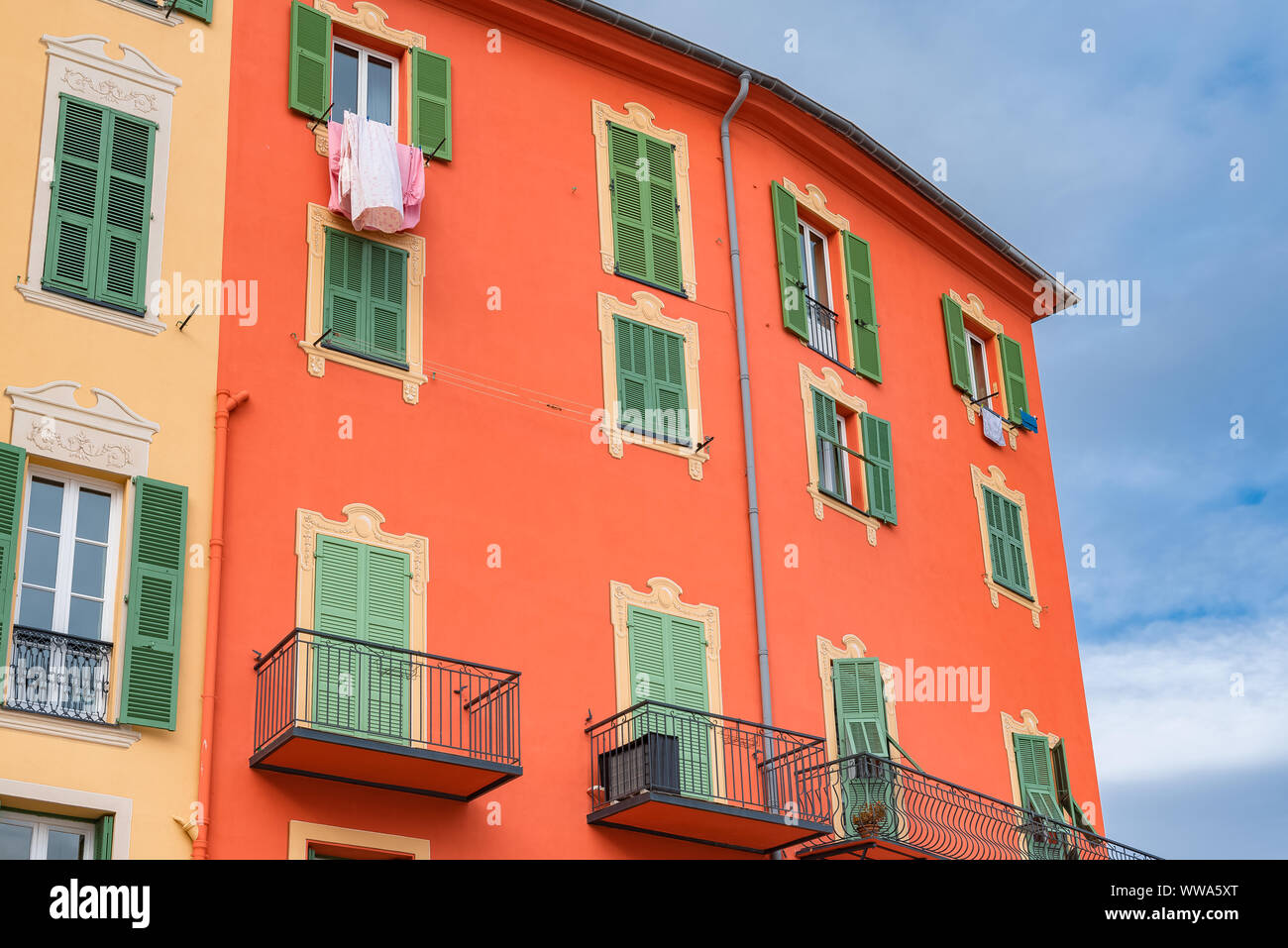 Nice, France, colorful facade, with typical windows and shutters, in a ...