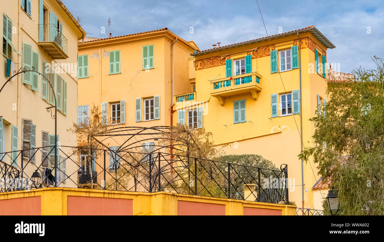 Nice, France, colorful facade, with typical windows and shutters, in a ...