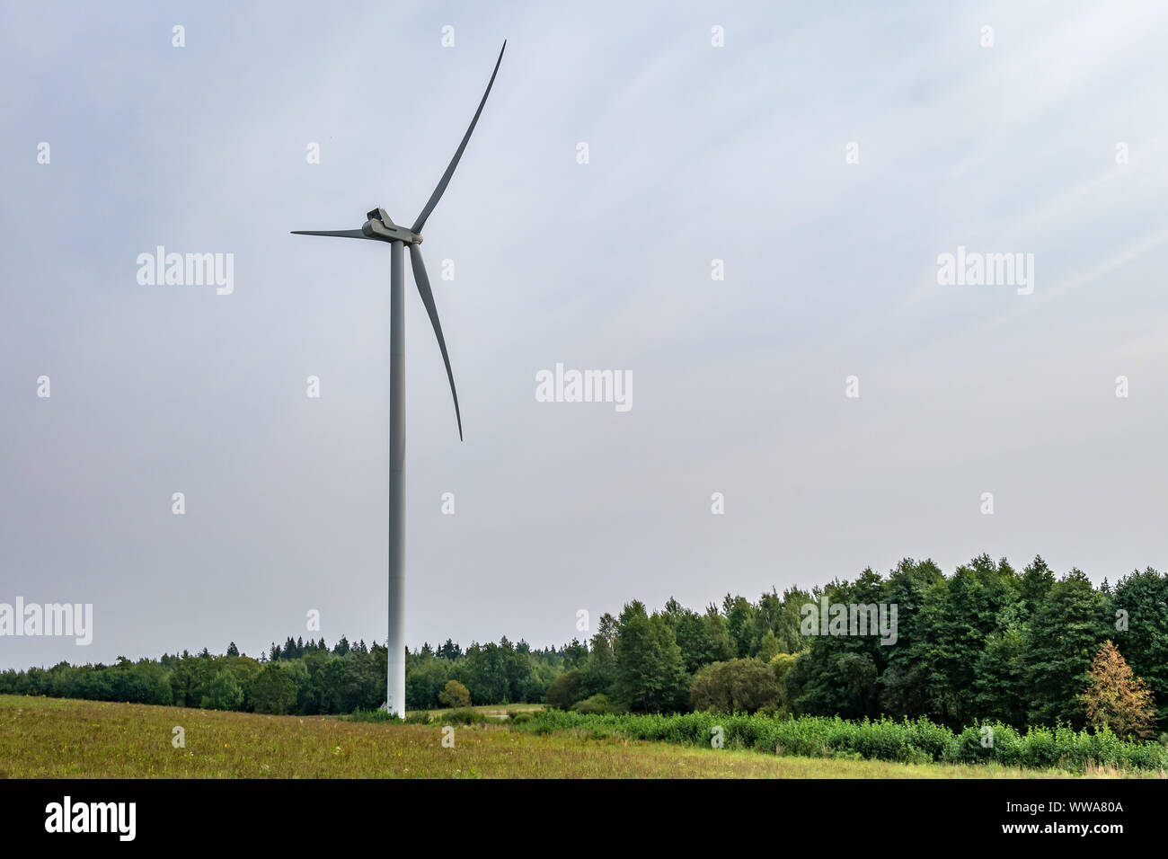 rotating blades of a windmill propeller on blue sky background. Wind ...
