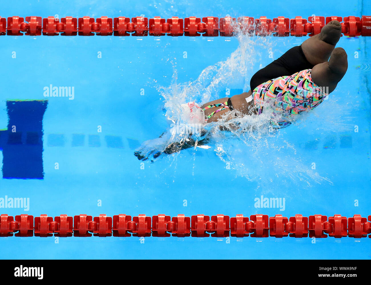 Kenya's Ann Wacuka dives in for the start of the Women's 100m Freestyle ...