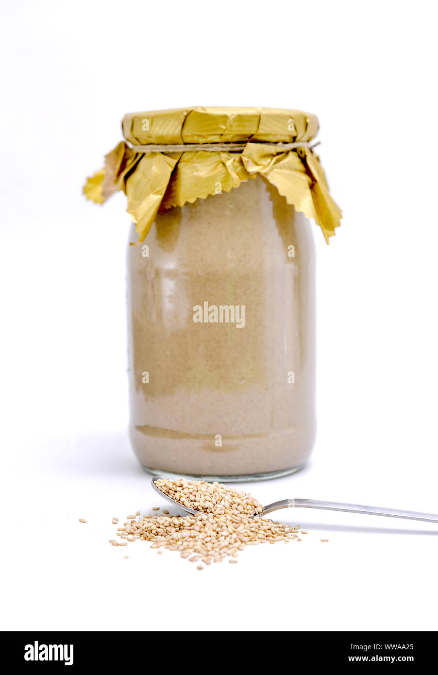 tahini syrup in jar on white background image Stock Photo - Alamy