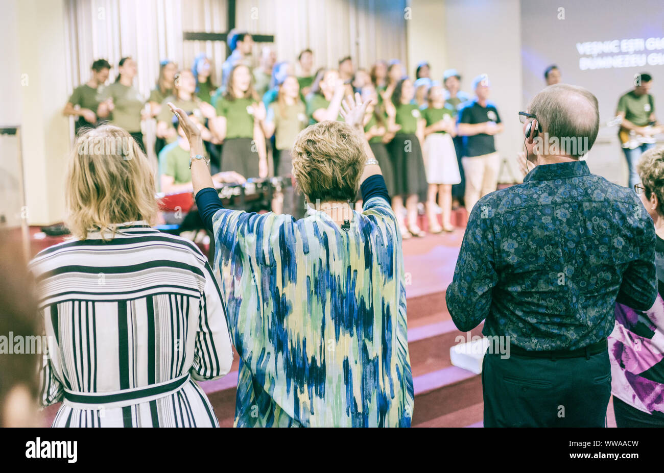 People at church worshiping God, with hands up Stock Photo - Alamy