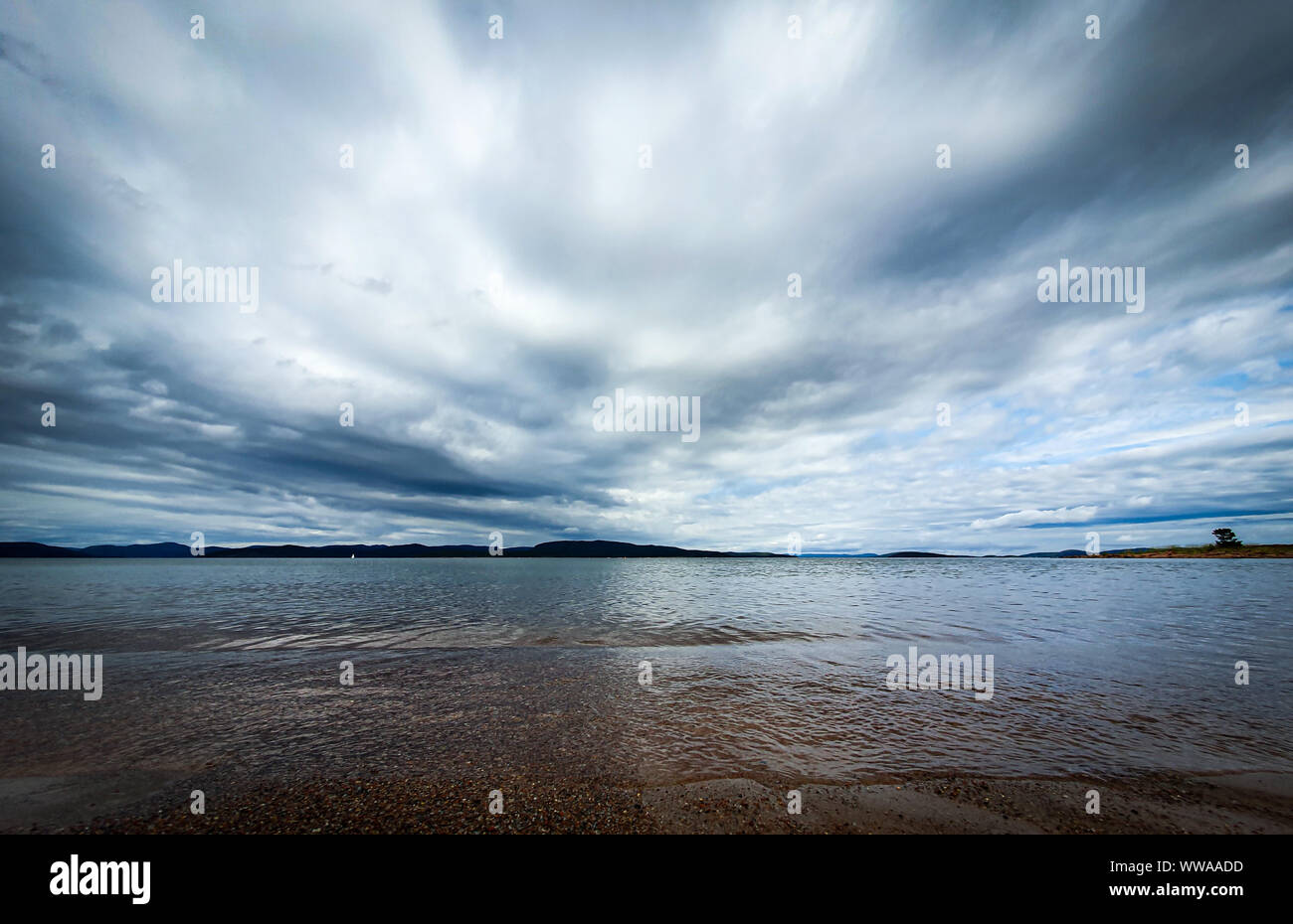 Dramatic sky over beautiful calm water in Gulf of Bothnia. Storsand ...
