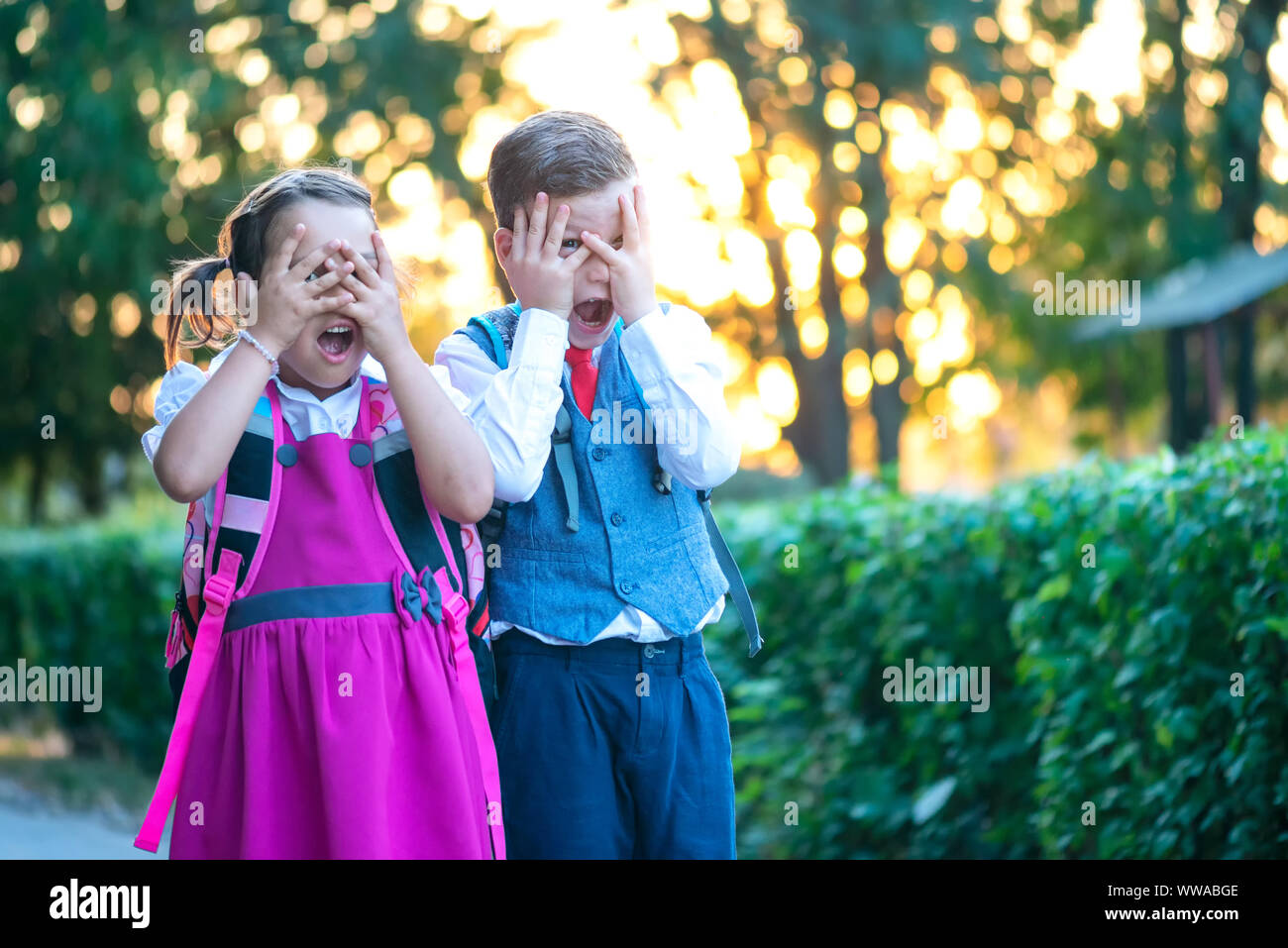 A boy and a girl with backpacks and being afraid of the first day of ...