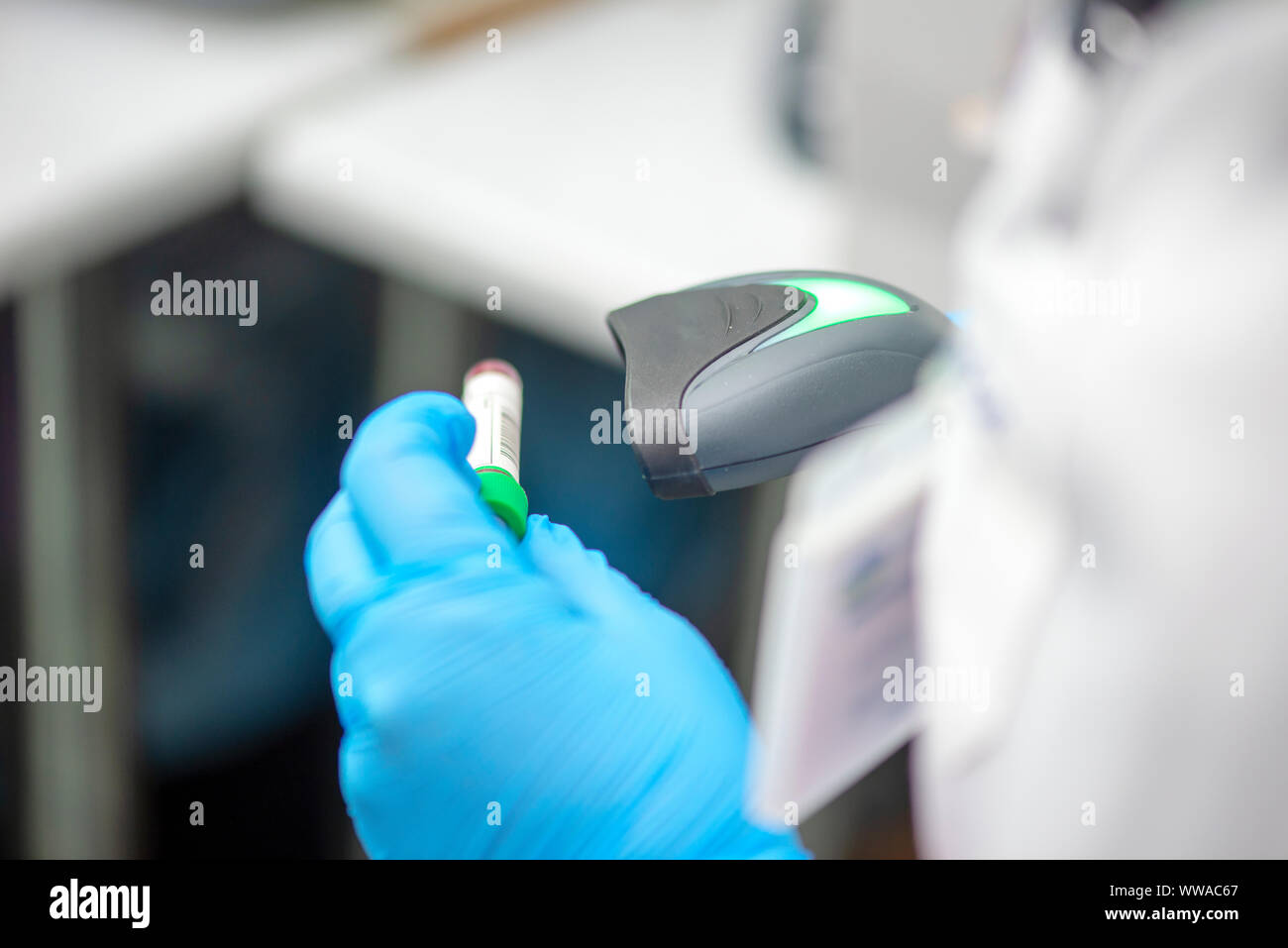 Bar code scanner and test tube over monitor of complete blood count ...