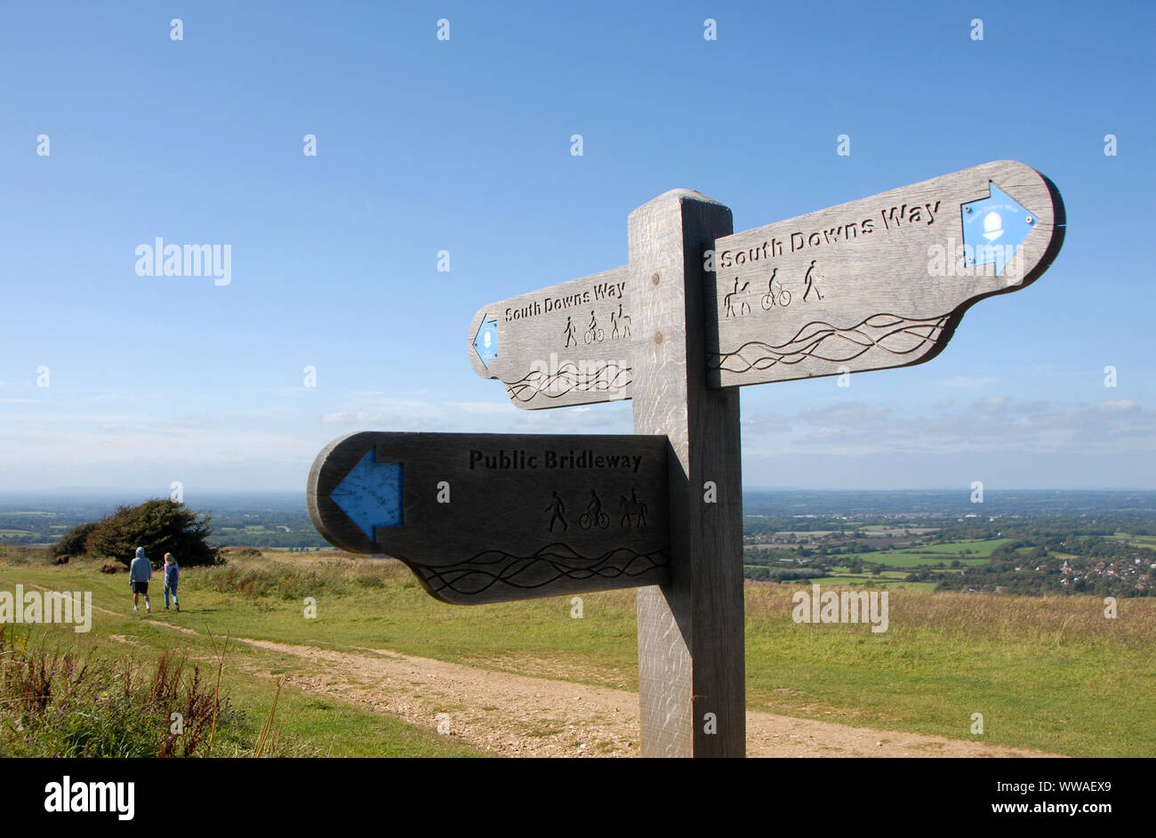 South Downs, Sussex, England, UK. A man and woman walking on the South ...