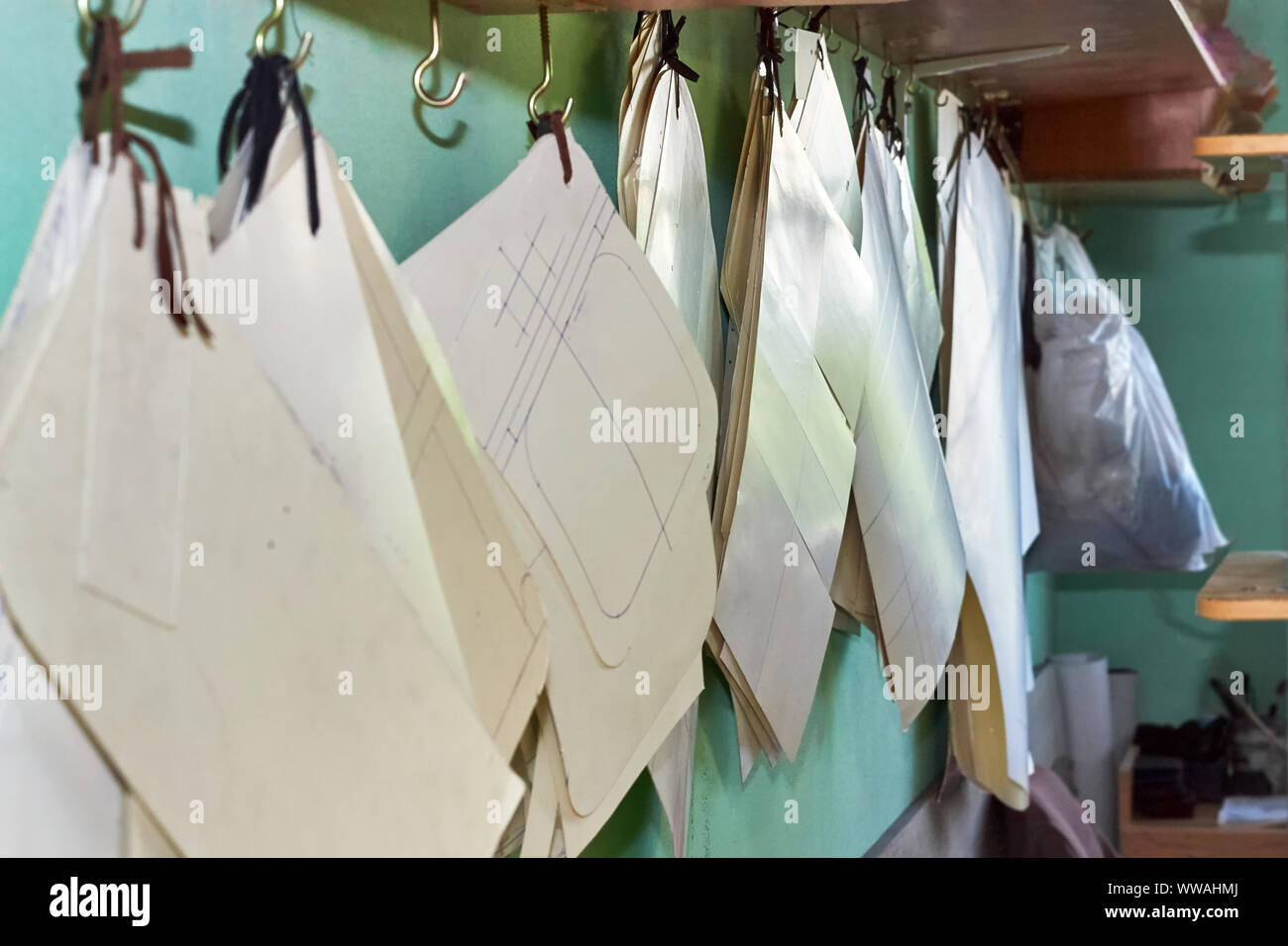 Professional tailor paper template set hanging on the wall in the ...