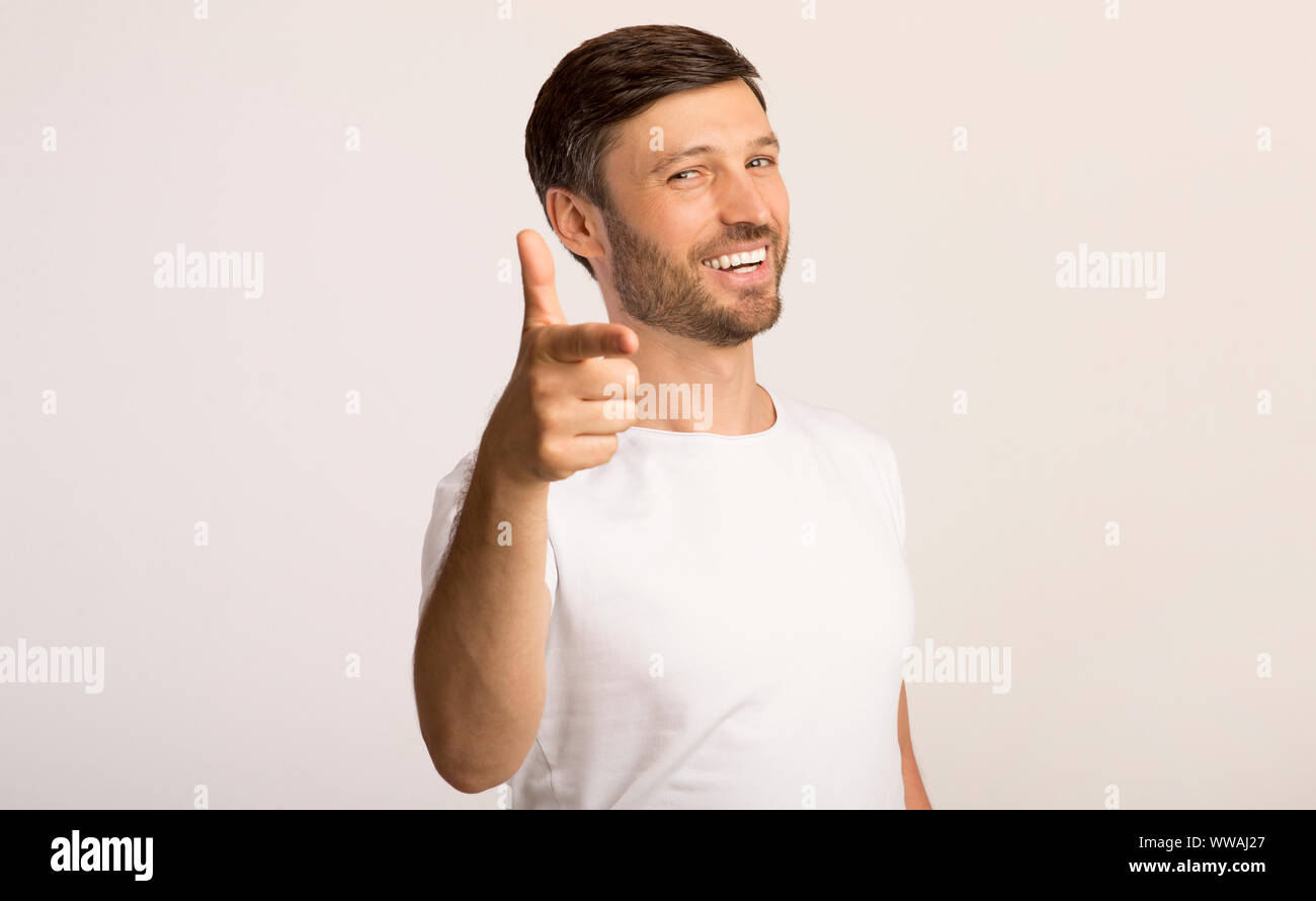 Guy pointing finger at camera standing on white background Stock Photo ...