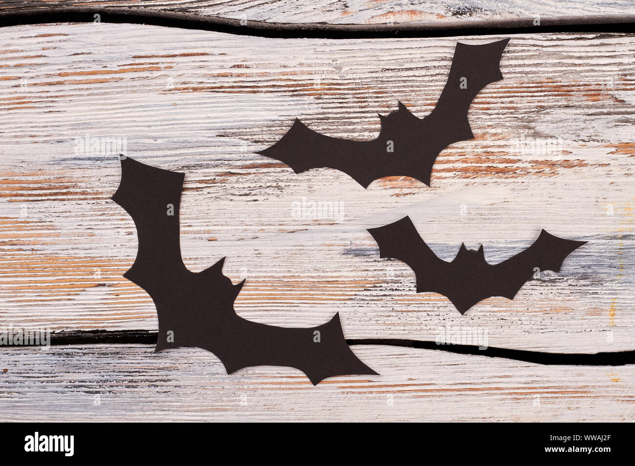 Paper bat cutouts on wooden background Stock Photo - Alamy