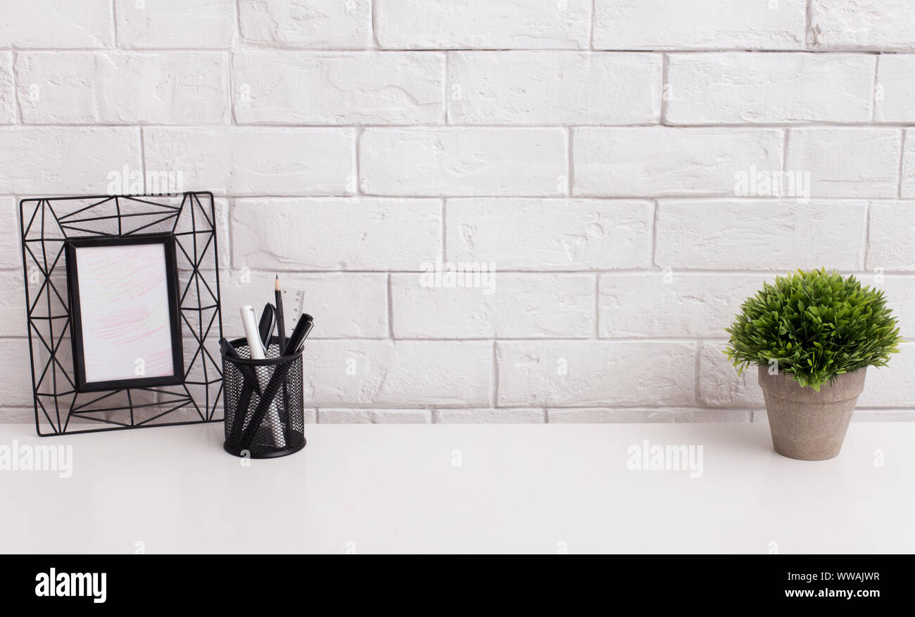 Modern office table with frame for photo and green plant Stock Photo ...