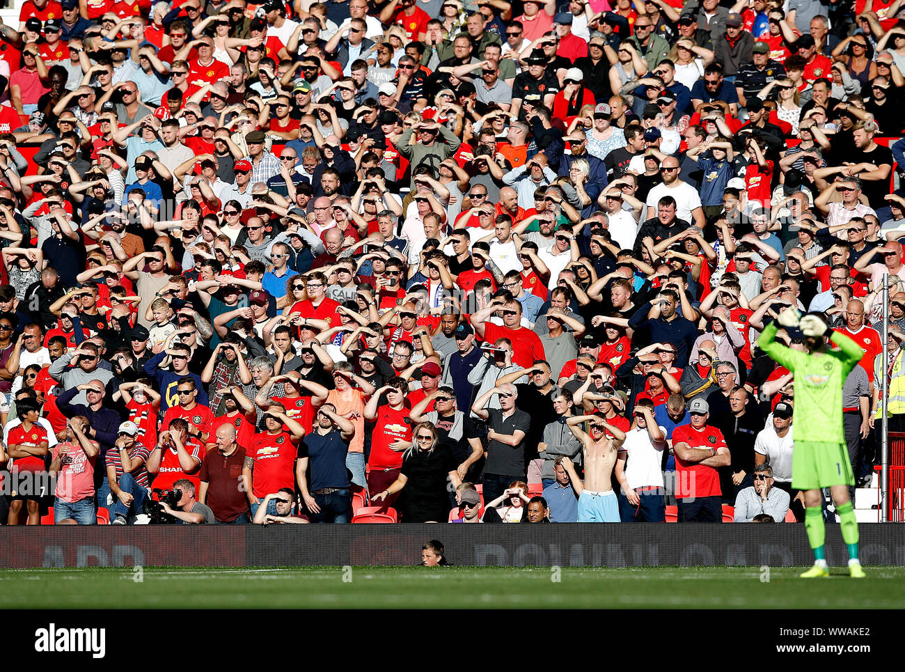 Manchester United fans shield their eyes from the sun during the ...