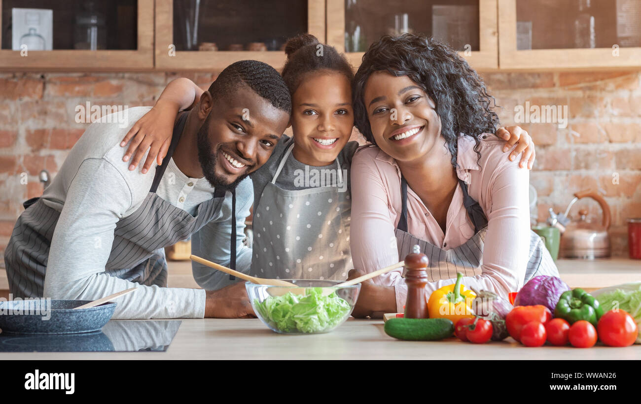 Cheerful african family having good time while cooking Stock Photo - Alamy