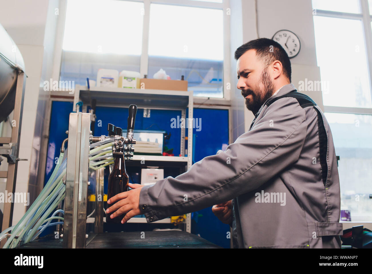 Portrait of brewer who is making beer on his workplace in the brew ...