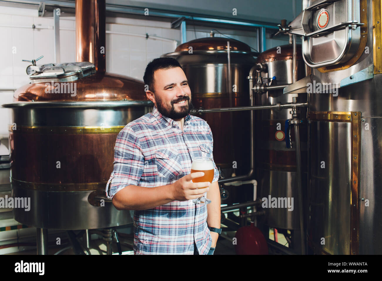 Oktoberfest festival. Tasting fresh brewed beer. Brewer holds glass ...