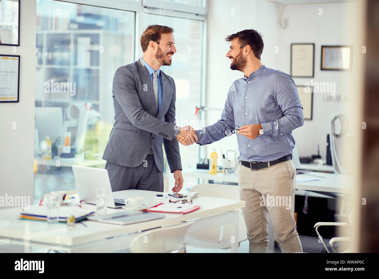 Young businessman successfully completed business meeting with smiling ...