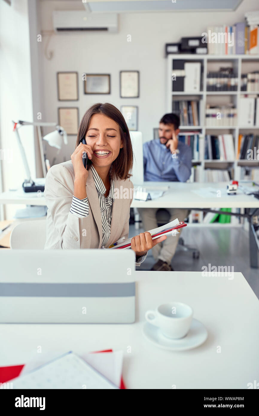 Business young woman manager use mobile phone at work Stock Photo - Alamy