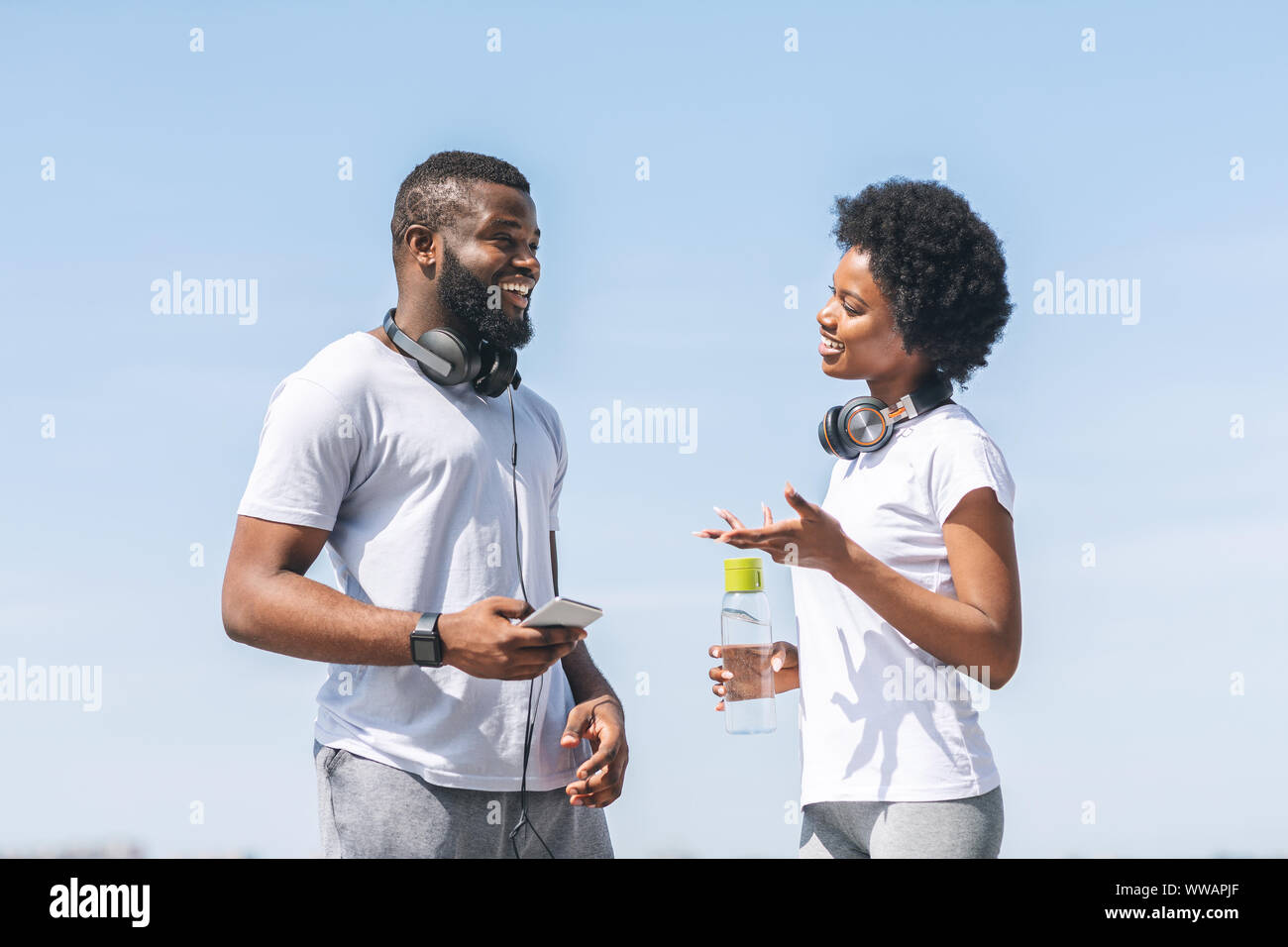 Afro Coach Guy Talking To Girl During Morning Jog Outside Stock Photo ...