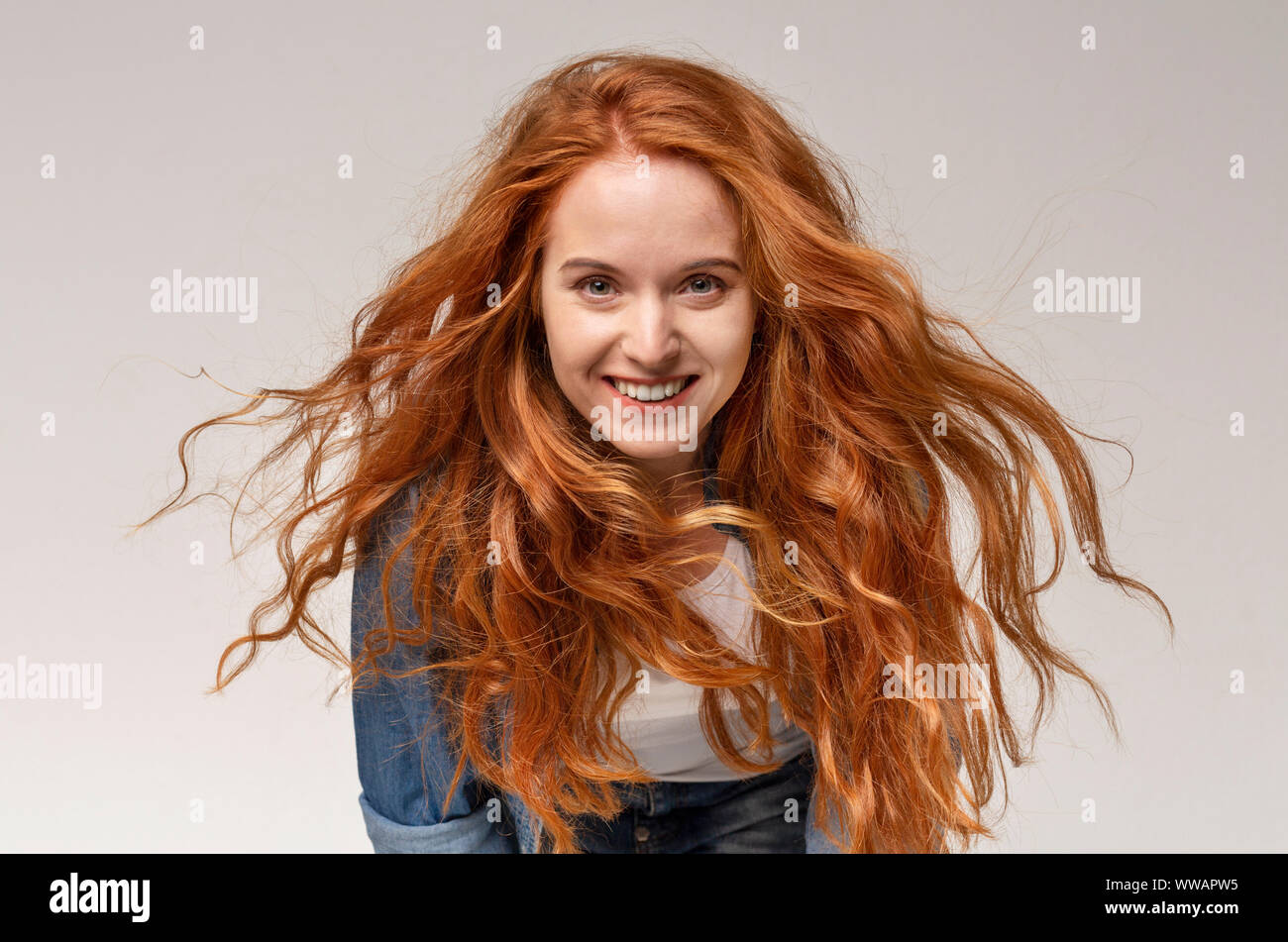 Charming redhead girl smiling and looking at camera Stock Photo - Alamy