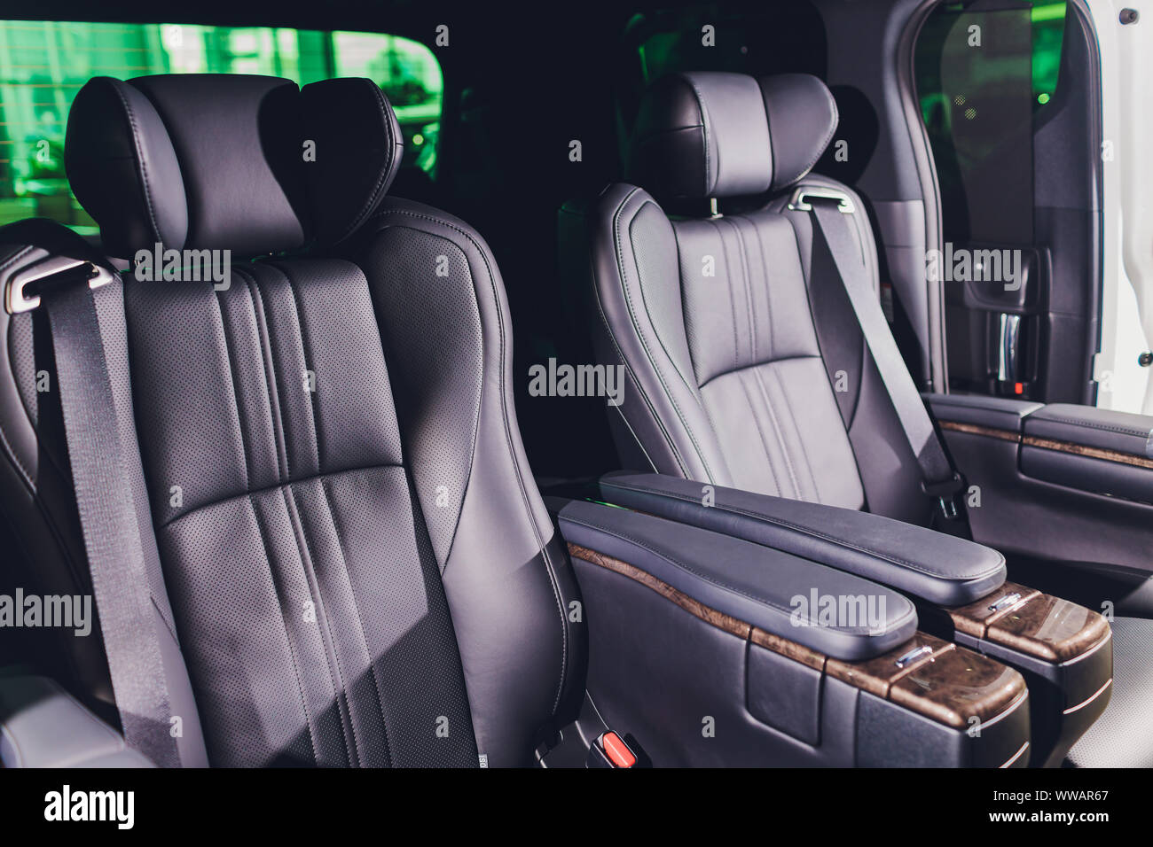 close-up of the black leather rear seats with footrest. modern car ...