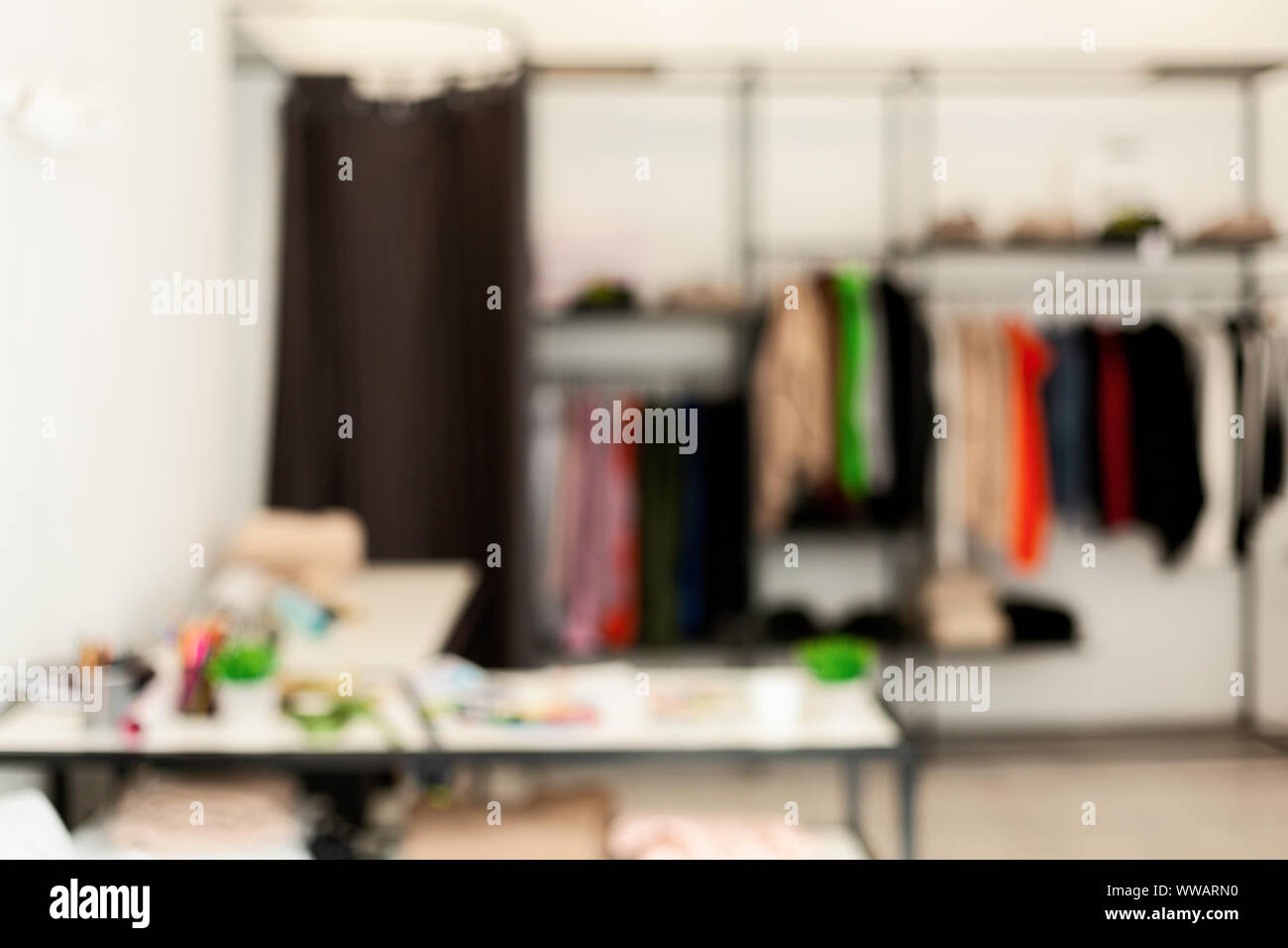 Blurred Background Of Fashion Designer Workshop With Clothes Hanger ...