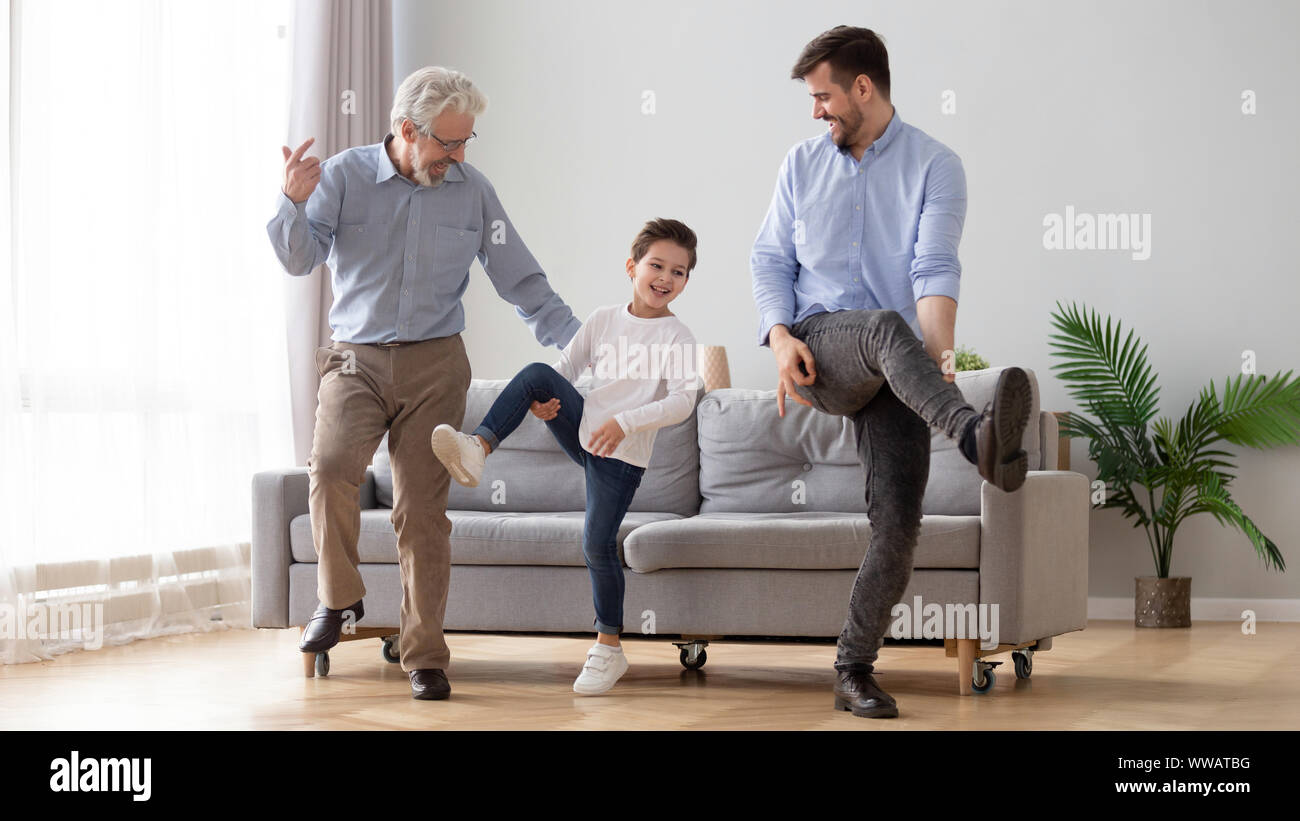 Happy three generation men family dancing together in living room Stock ...