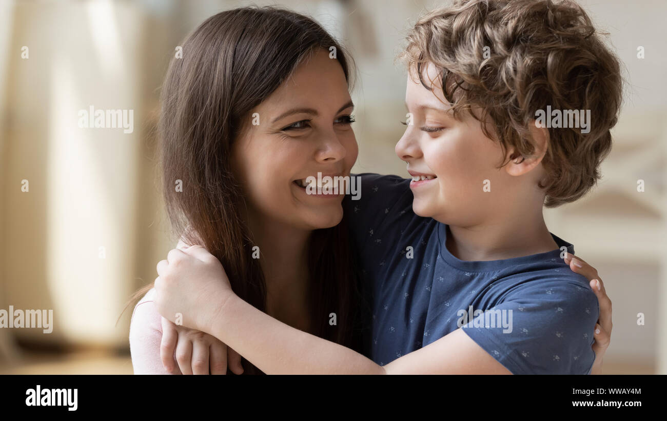 Young beautiful mother hugging little schoolboy son Stock Photo - Alamy