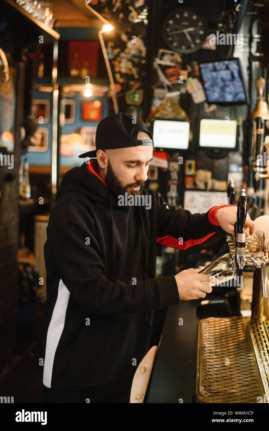 Bartender pours dark beer in hi-res stock photography and images - Alamy