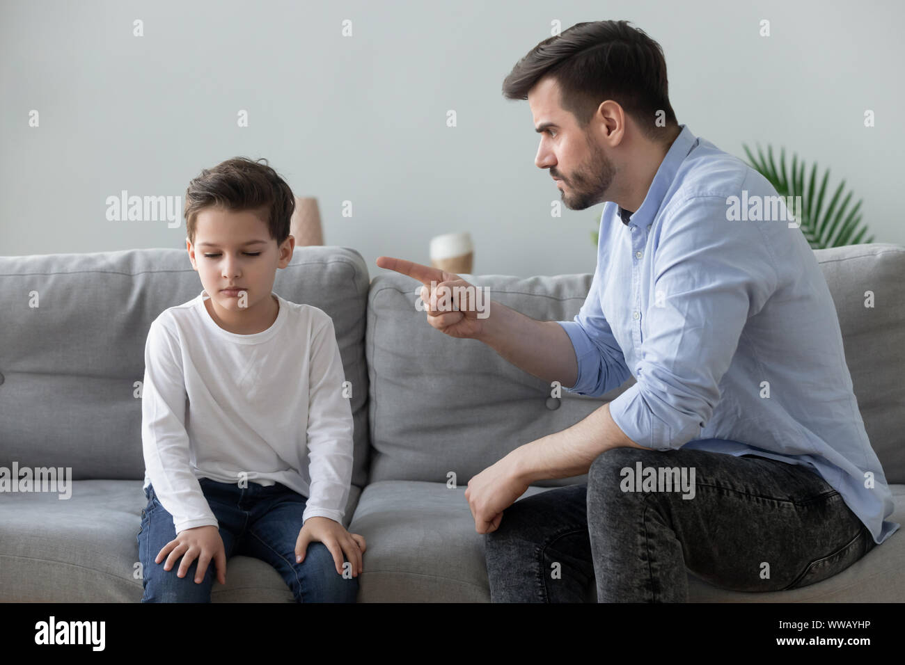 Angry father scolding sad kid son for bad behavior Stock Photo - Alamy