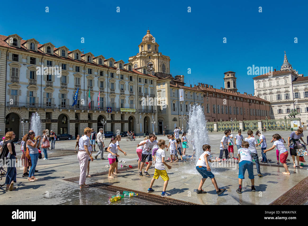 Children playing in the The fountains in Piazza Castello, a prominent ...