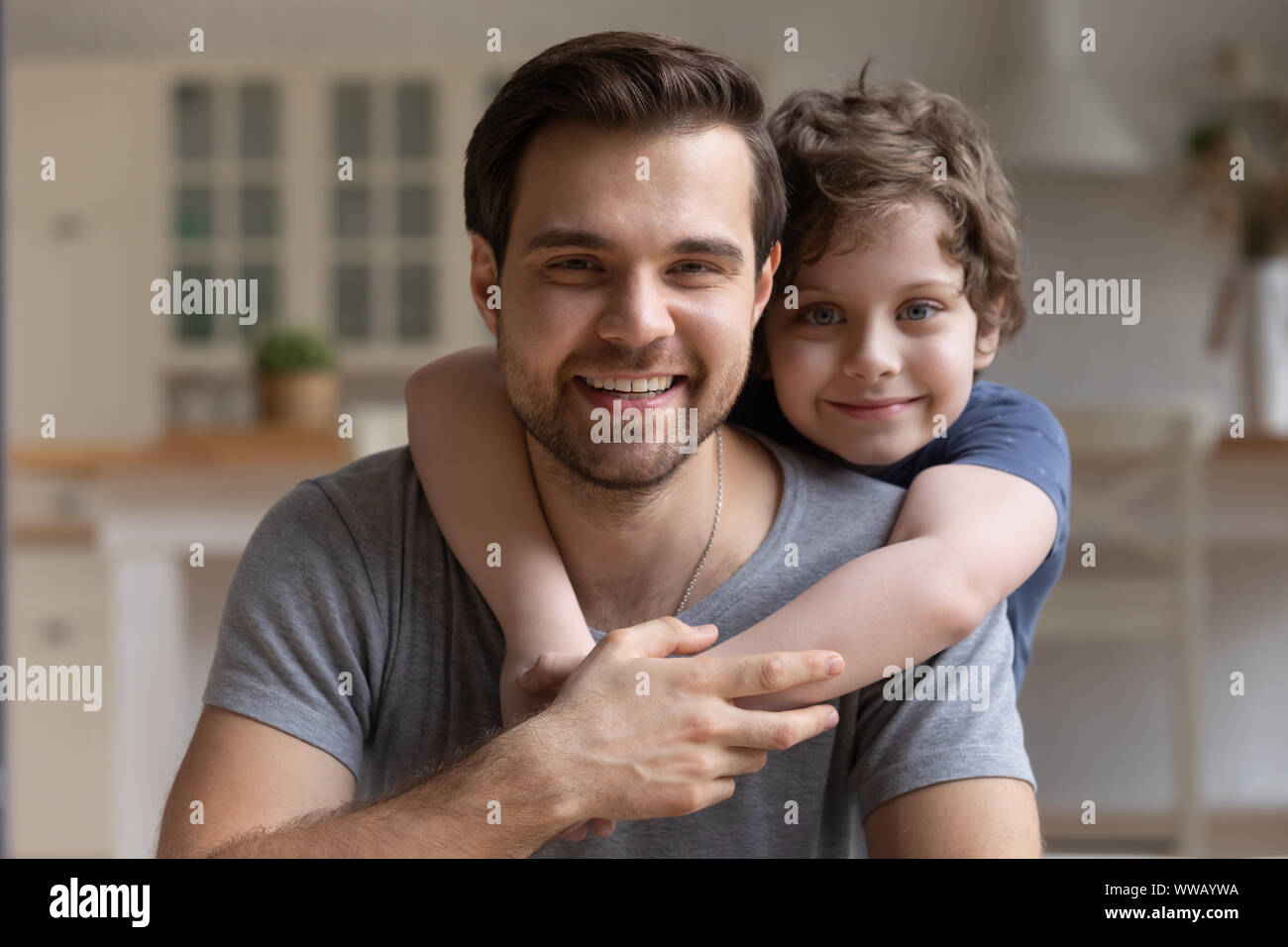 Happy little cute boy hugging smiling young father Stock Photo - Alamy