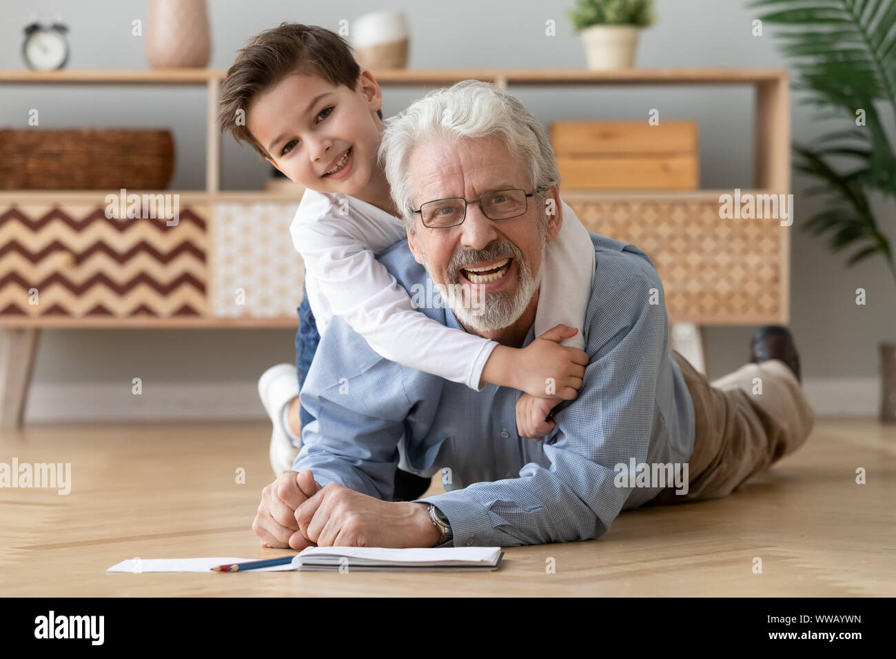 Happy old grandfather and grandson drawing looking at camera Stock ...