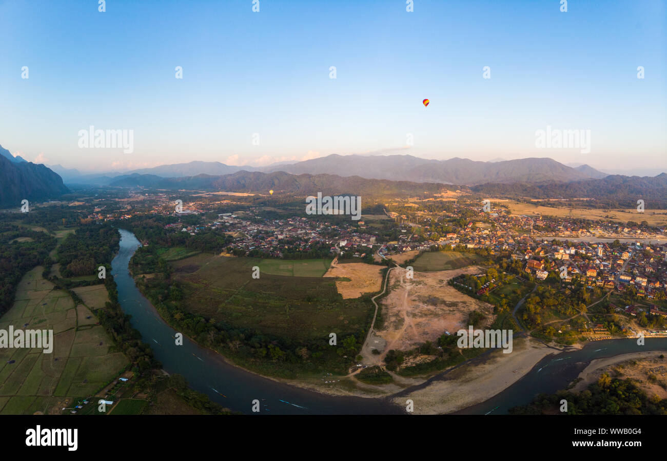 Aerial: hot air balloons in Vang Vieng backpacker travel destination in ...
