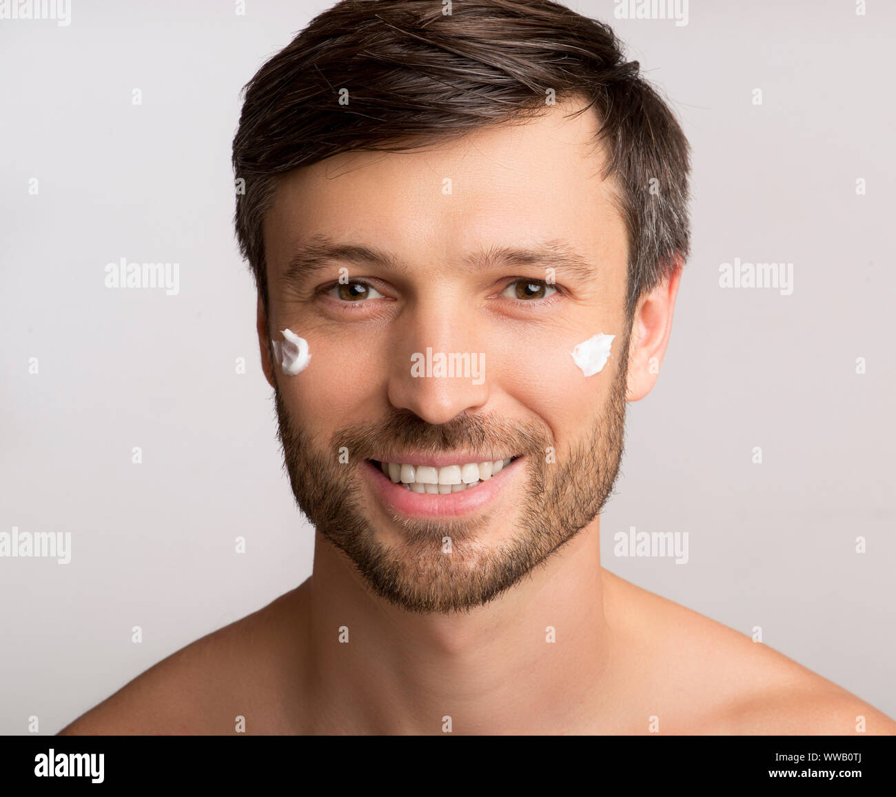 Man Applying Anti-Aging Cream On Face Over White Background Stock Photo ...