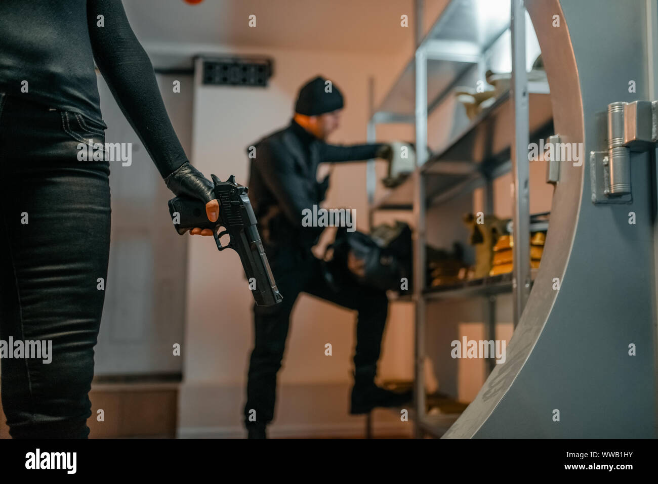 Two robbers in black uniform hacked the vault Stock Photo - Alamy