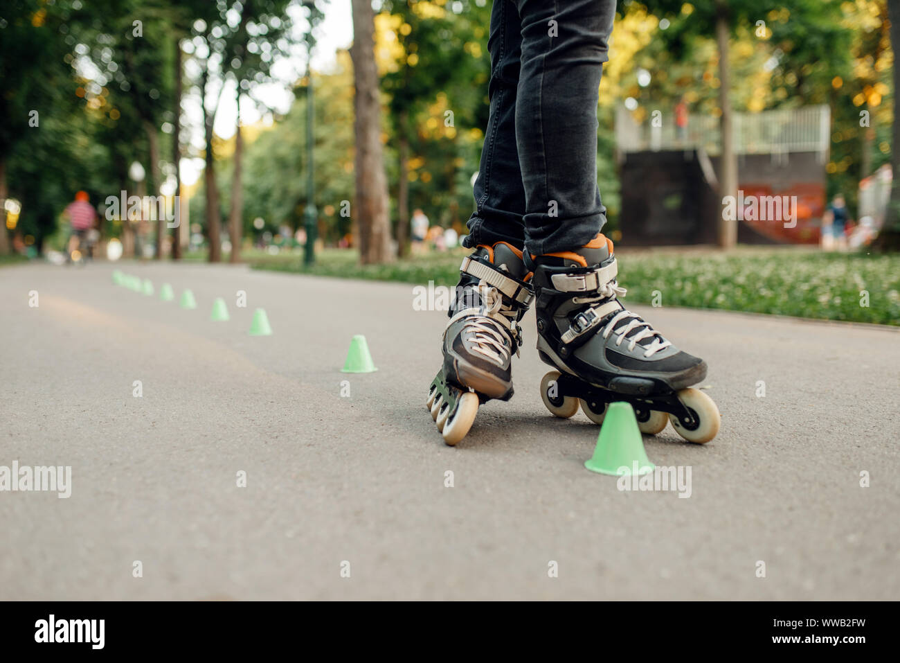 Roller skating, skater rolling around the cones Stock Photo - Alamy