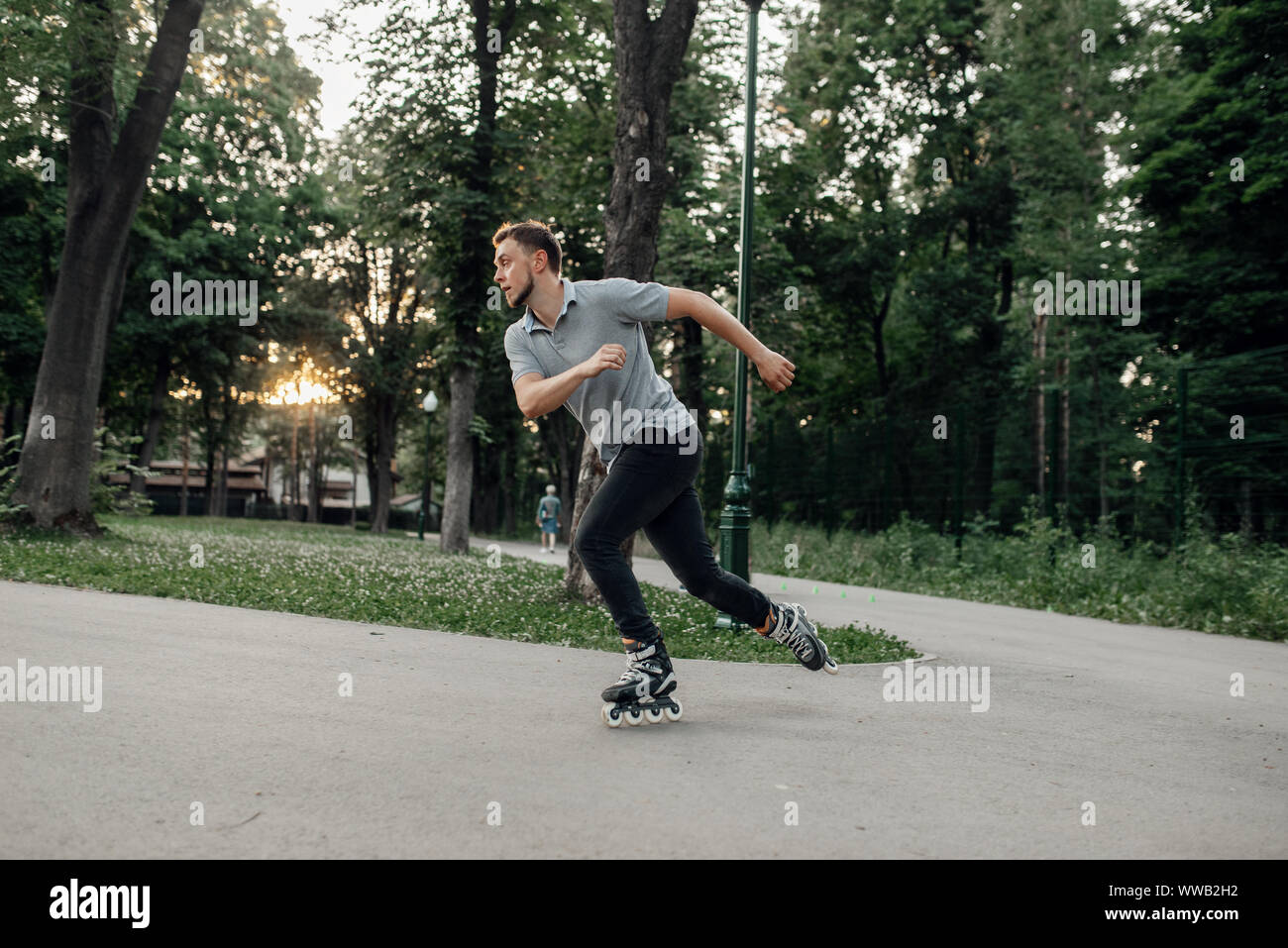 Roller skating, male skater rolling in action Stock Photo - Alamy