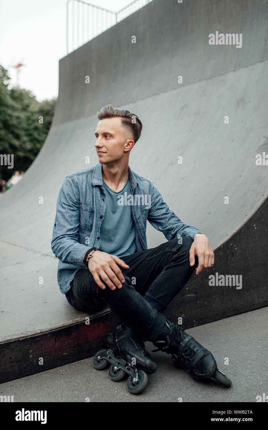 Roller skating, male skater poses on the ramp Stock Photo - Alamy