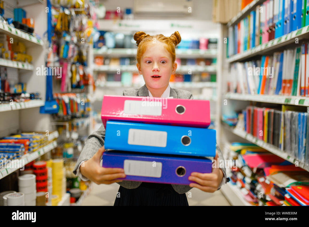 School girl holds folders in stationery store Stock Photo - Alamy