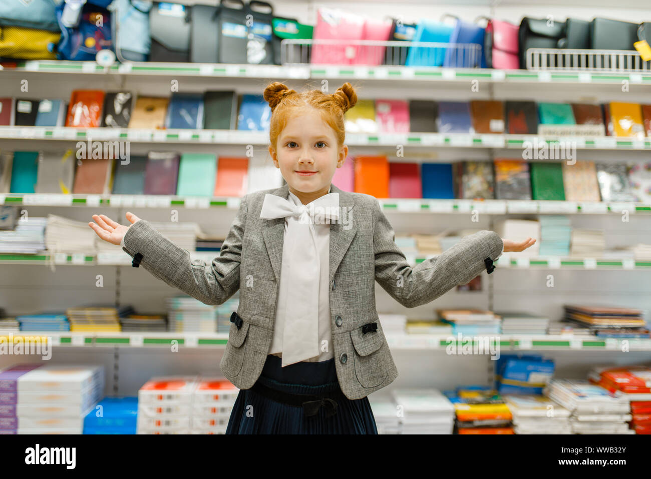 Girl at the shelf in stationery store, front view Stock Photo - Alamy