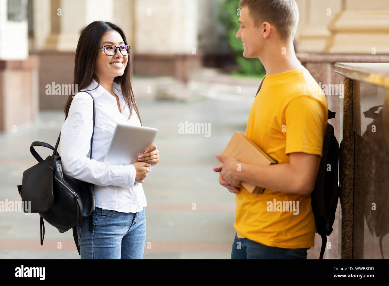 Classmates talking in college campus during break Stock Photo - Alamy